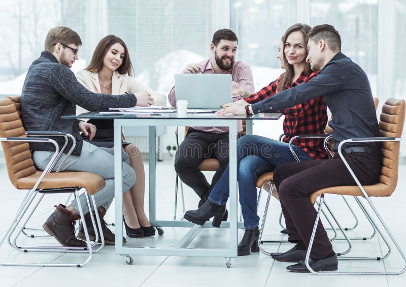 Business Team Discussing Work Documents Sitting Behind a Desk Stock ...