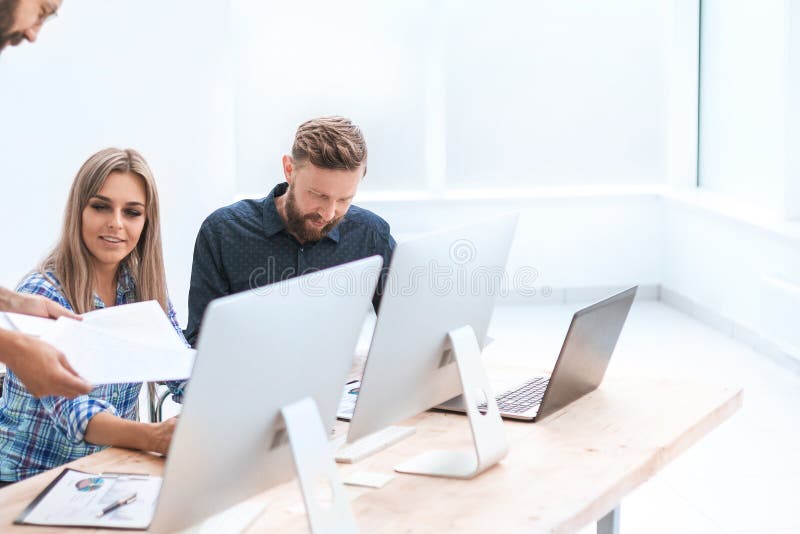 Business Team Discussing Working Documents in a Light Office. Stock ...