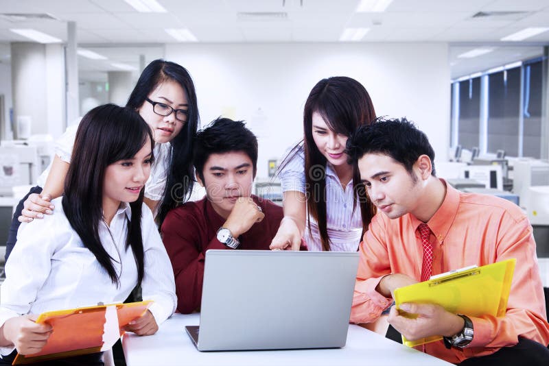 Business Team Discussion on Laptop at Office Stock Photo - Image of ...