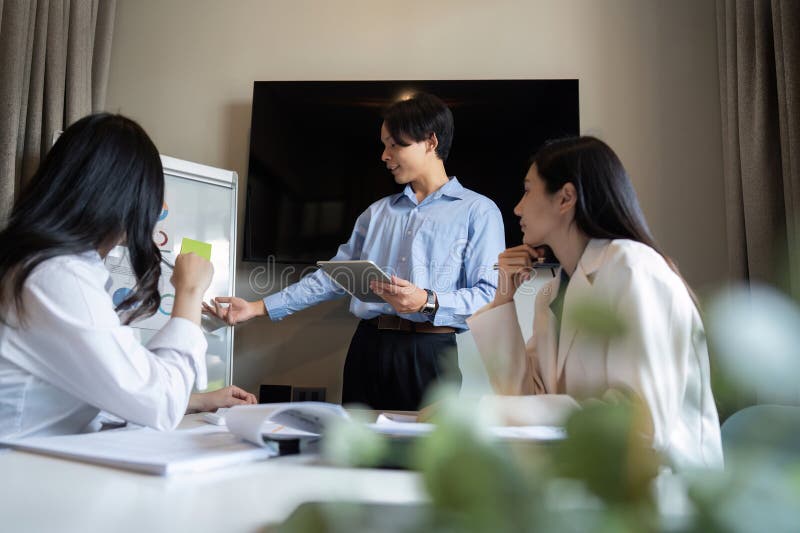 Business Team Engaged in Analysis Discussion in Modern Office Setting ...