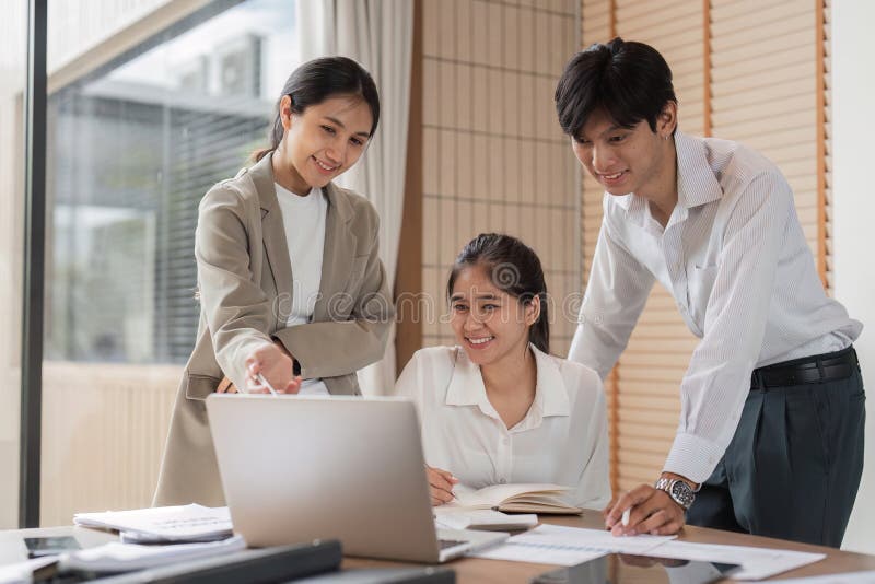 Business Team Collaborating on Project in Modern Office Setting with ...