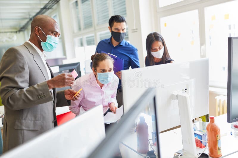 Business Team with Face Mask because of Covid-19 on the PC Stock Image ...