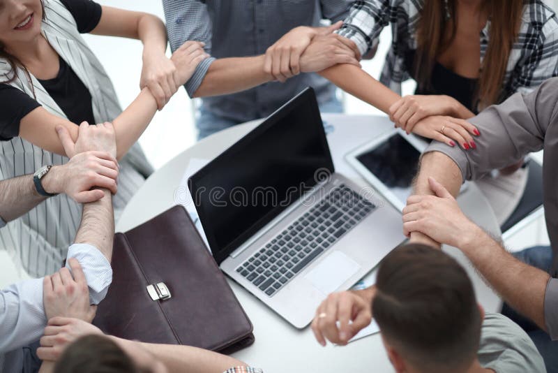 Business Team Forms a Circle of Hands in the Workplace Stock Image ...