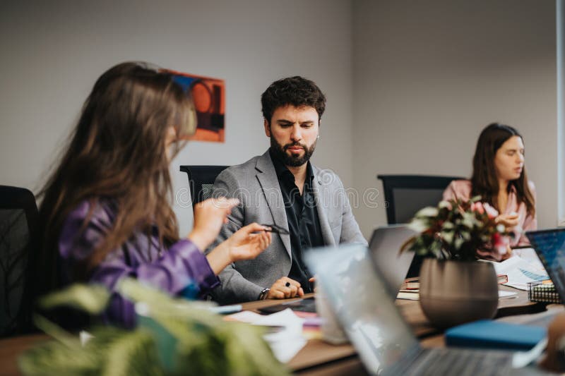 Business Team Involved in a Serious Discussion during a Project Meeting ...