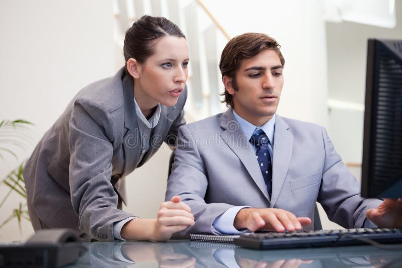Business Team Looking at Computer Screen Together Stock Photo - Image ...