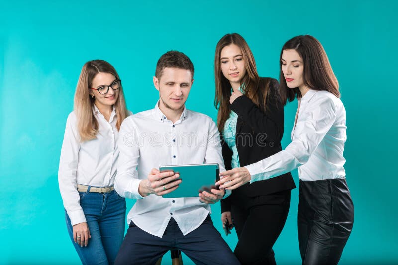 Business Team Looks at the Digital Tablet Screen. Business People Using ...