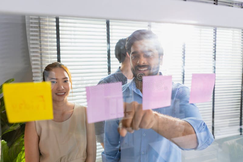 Business Team Meeting Planning New Strategy Using Colored Sticky Notes ...