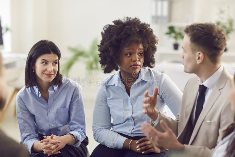 Business Team Engaging in Discussion while Sitting in a Circle during a ...