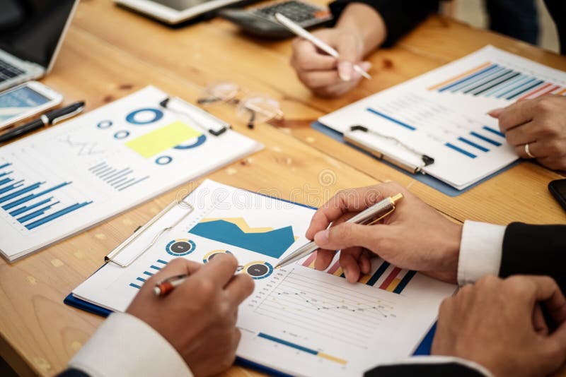 Business Team Professionals Working Analyzing Data with Financial ...