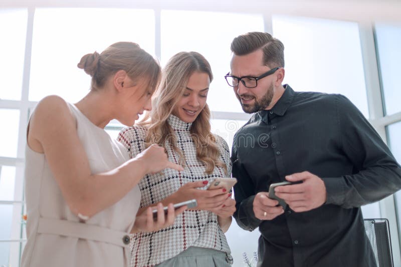 Business Team Reading Emails on Their Smartphones. Stock Image - Image ...