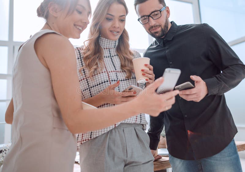 Business Team Reading Emails on Their Smartphones. Stock Photo - Image ...
