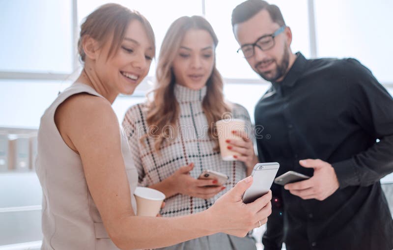 Business Team Reading Emails on Their Smartphones. Stock Photo - Image ...