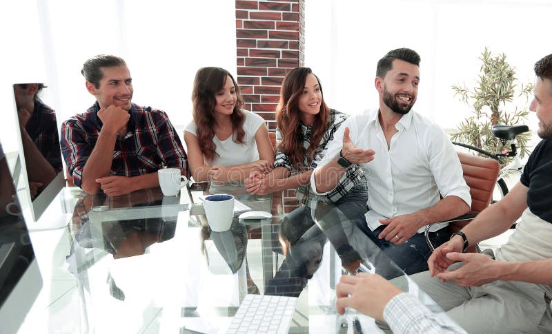 Business Team Sitting at a Modern Desk. Stock Image - Image of ...