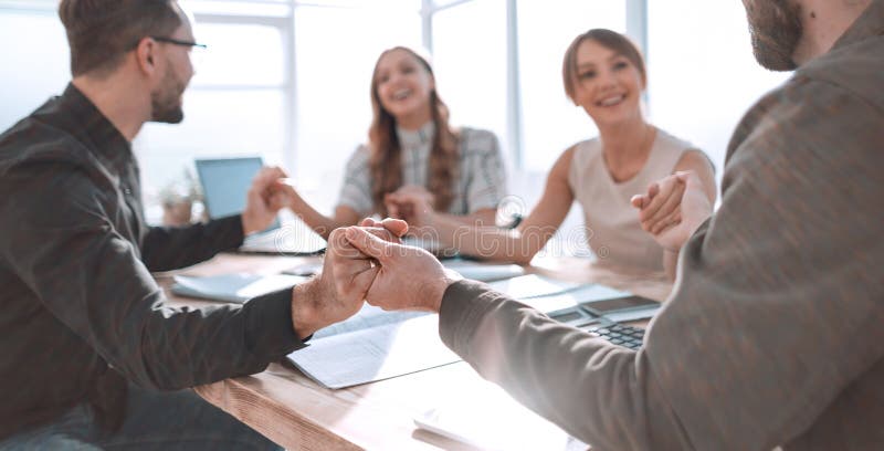 Business Team Sitting at the Table and Showing Their Unity Stock Photo ...