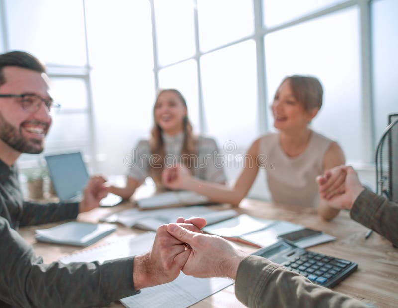 Business Team Sitting at the Table and Showing Their Unity Stock Photo ...
