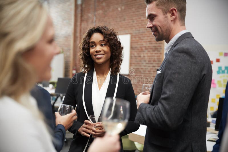 Business Team Socializing at after Works Drinks in Modern Office Stock ...