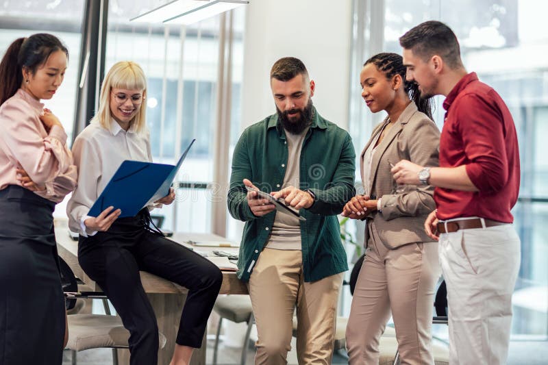 A Business Team is Standing in a Modern Office and Having a Discussion ...