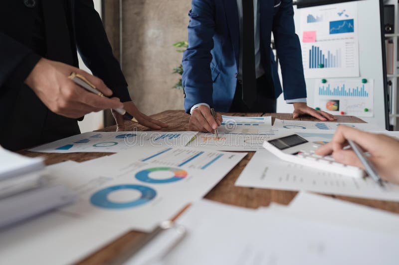 Business Team Using a Calculator To Calculate the Numbers of Statistic ...