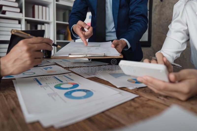 Business Team Using a Calculator To Calculate the Numbers of Statistic ...
