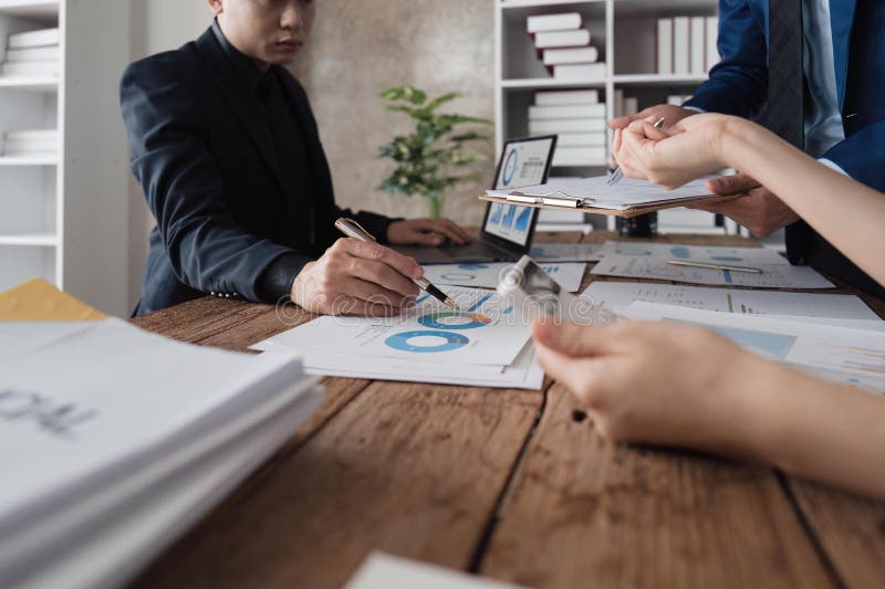 Business Team Using a Calculator To Calculate the Numbers of Statistic ...
