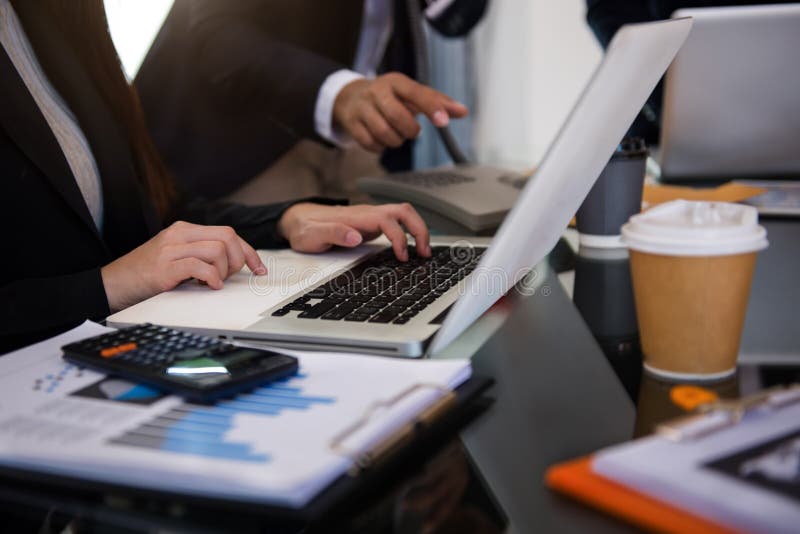 Business Team Using a Calculator To Calculate the Numbers. Stock Image ...