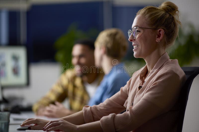 Business Team Using Computers at Desks in Office Working Late Stock ...