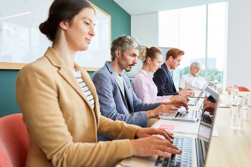 Business Team Using Laptops while Working Together in Conference Room ...