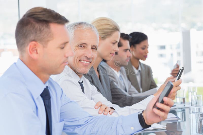 Business Team Using Their Mobile Phone Stock Image - Image of mobile ...