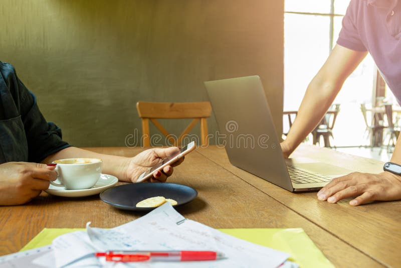 Business Team Work Using Cell Phone and Laptop Working with Documents ...