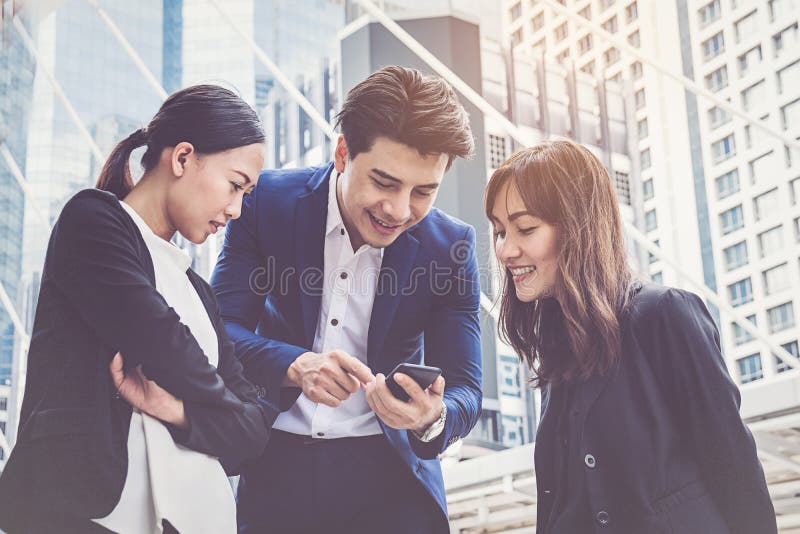 Business Team Working at City, Looking a Mobile Phone Stock Photo ...