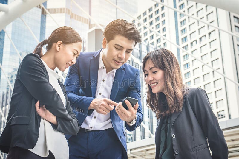 Business Team Working at City, Looking a Mobile Phone Stock Image ...