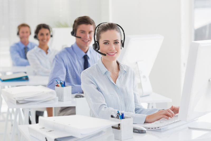 Business Team Working on Computers and Wearing Headsets Stock Photo ...