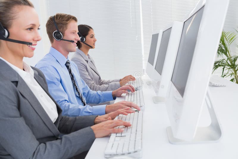 Business Team Working on Computers and Wearing Headsets Stock Image ...
