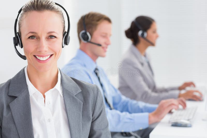 Business Team Working on Computers and Wearing Headsets Stock Photo ...