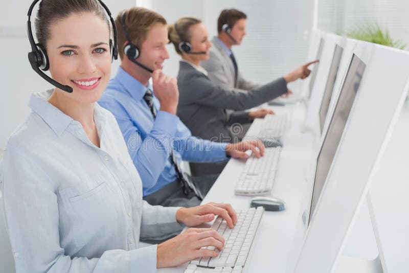 Business Team Working on Computers and Wearing Headsets Stock Image ...
