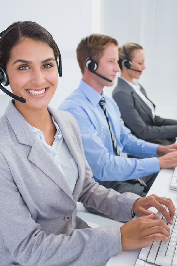 Business Team Working on Computers and Wearing Headsets Stock Image ...