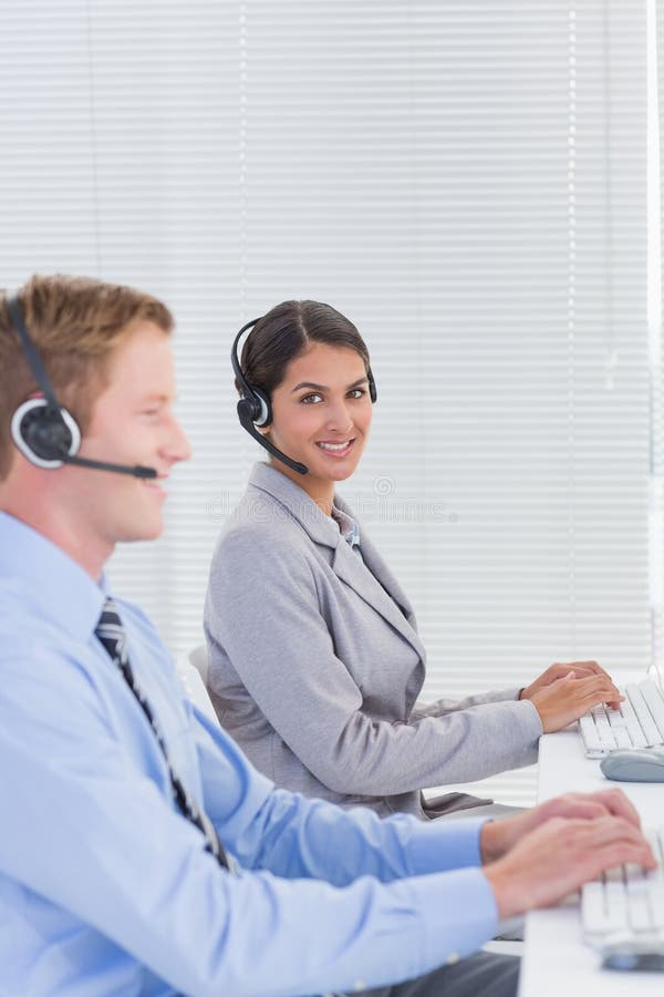 Business Team Working on Computers and Wearing Headsets Stock Image ...