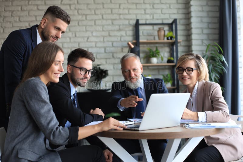 Business Team Working on Laptop To Check the Results of Their Work ...