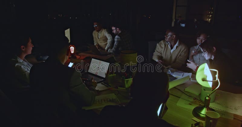 Business Team Working Late at Night in Office on a Project ...
