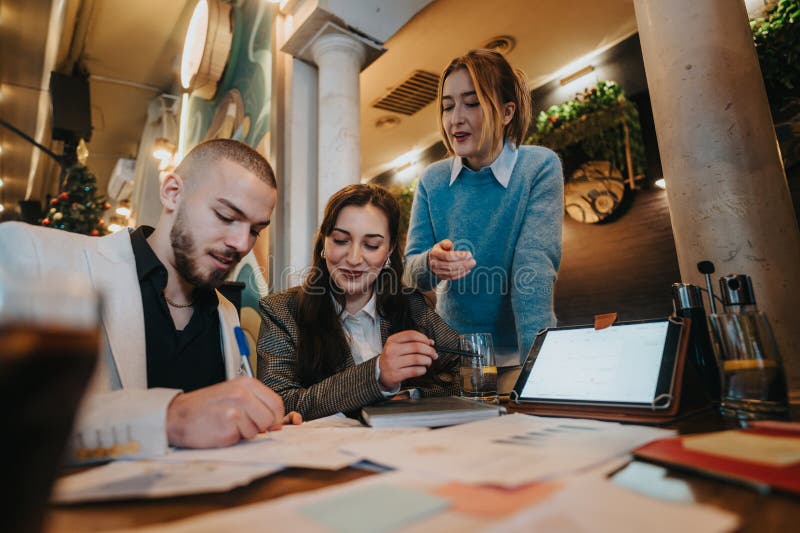 Business Teamwork Discussing Ideas in a Modern Cafe Setting Stock Photo ...