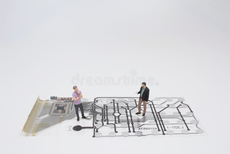 A Business and Technology Concept. Two Businessman Miniature Figures ...