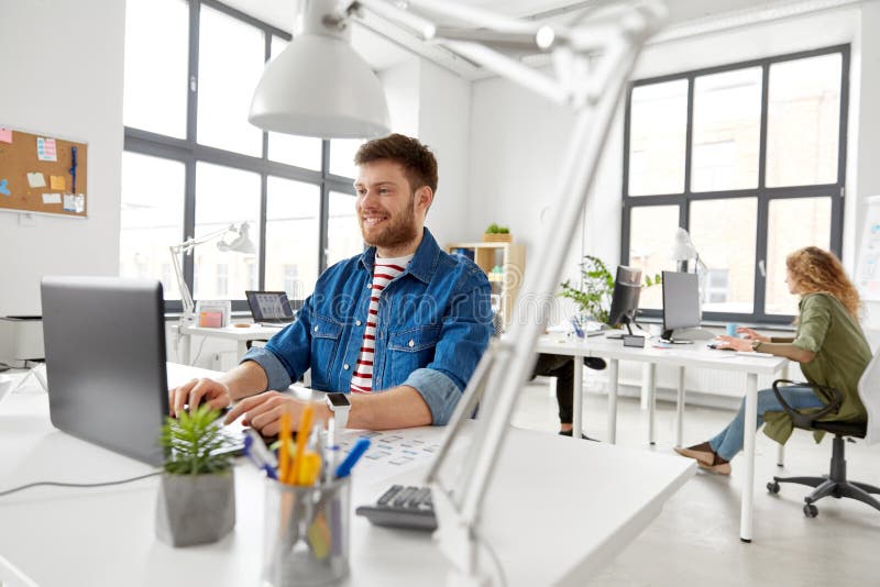 Smiling Creative Man with Laptop Working at Office Stock Photo - Image ...