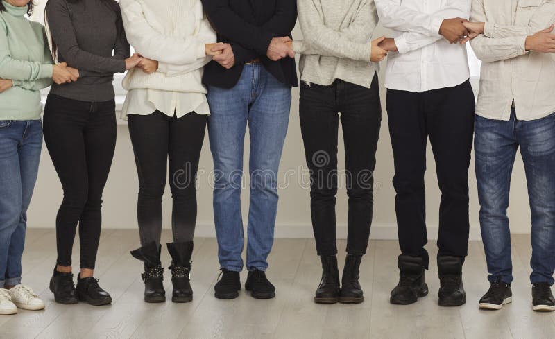 Cropped Image of a People Standing in a Row and Holding Hands ...