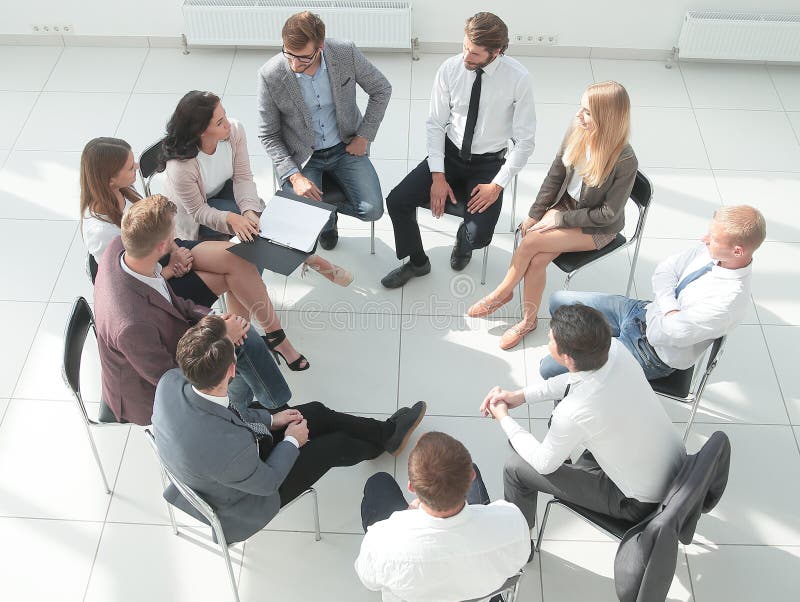 Business Training Participants Sitting in a Circle and Looking at the ...
