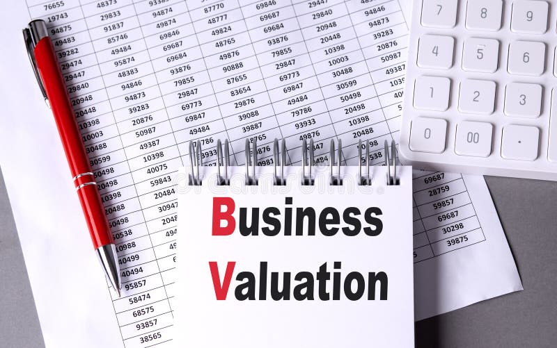 BUSINESS VALUATION Text on Notebook with Chart , Pen and Calculator ...
