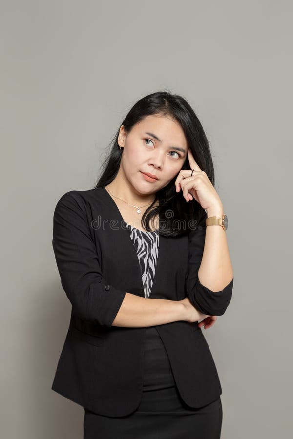 Business Woman Daydreaming with Index Finger on Head Stock Photo ...