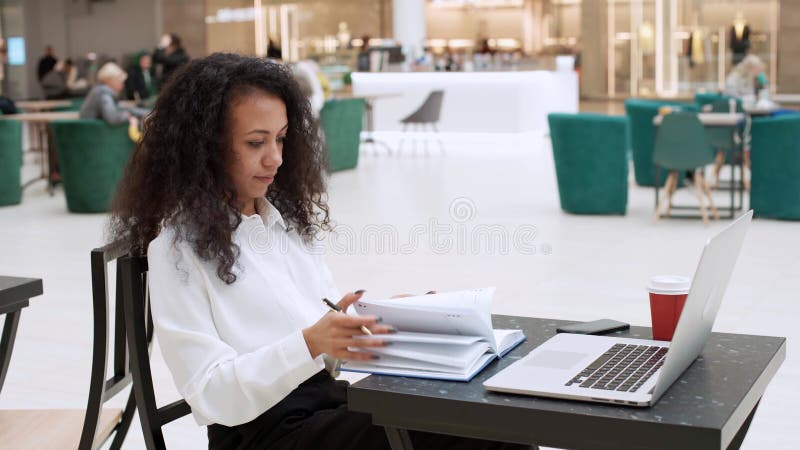 Business Woman is Flipping through and Making a Note in Her Diary ...