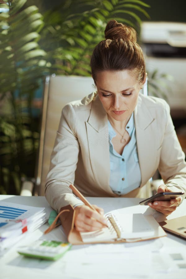 Business Woman in Green Office Using Smartphone Applications Stock ...