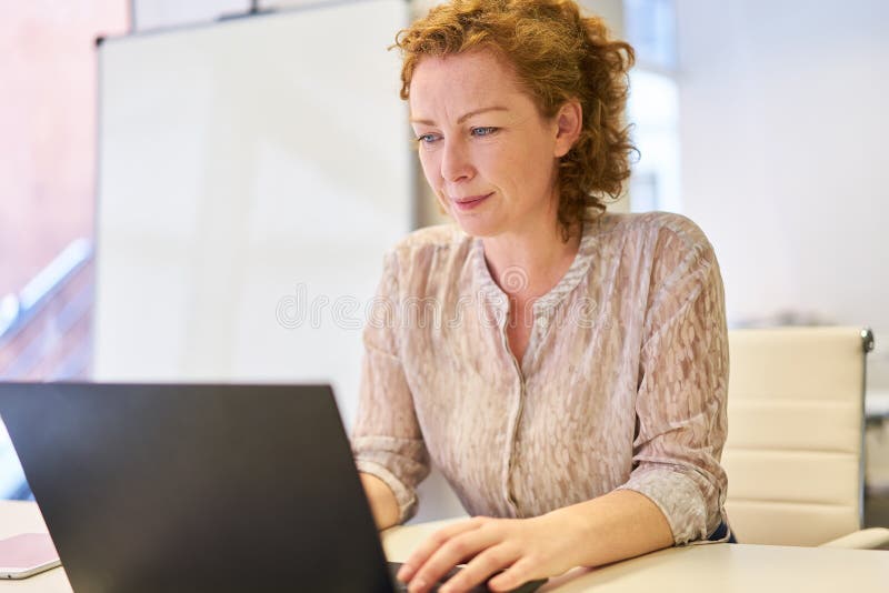 Business Woman on Laptop Computer Online in Office Stock Photo - Image ...