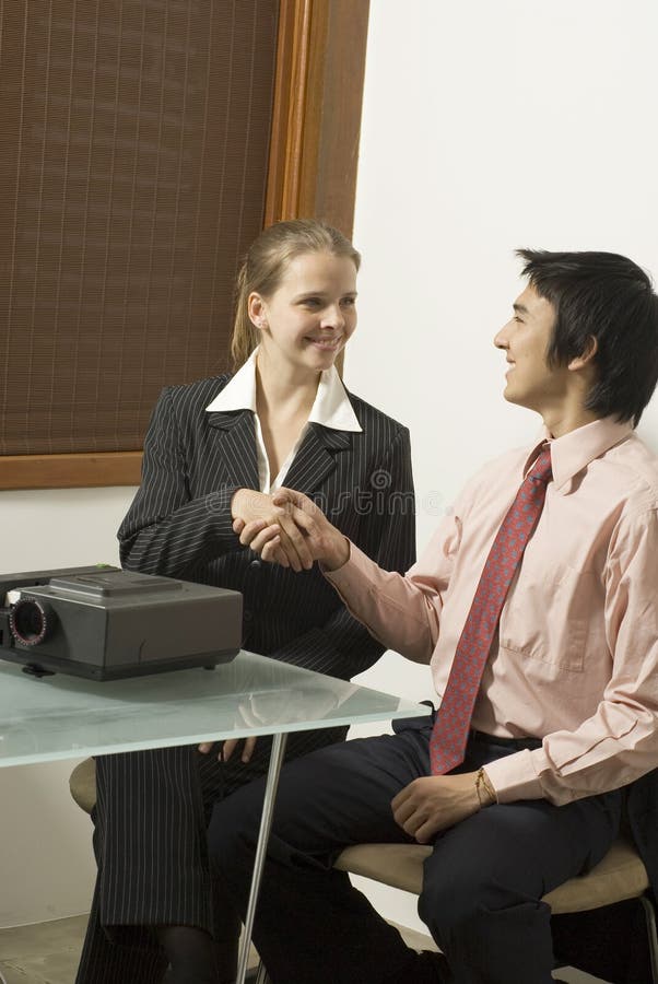 Receptionist Greeting Man at Front Desk Stock Image - Image of woman ...